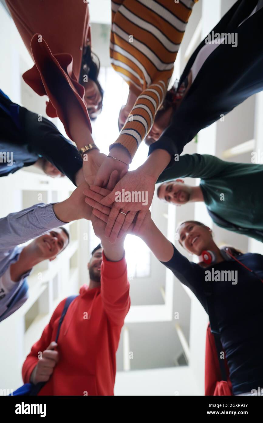 Group of young students in electronics classroom celebrating ...