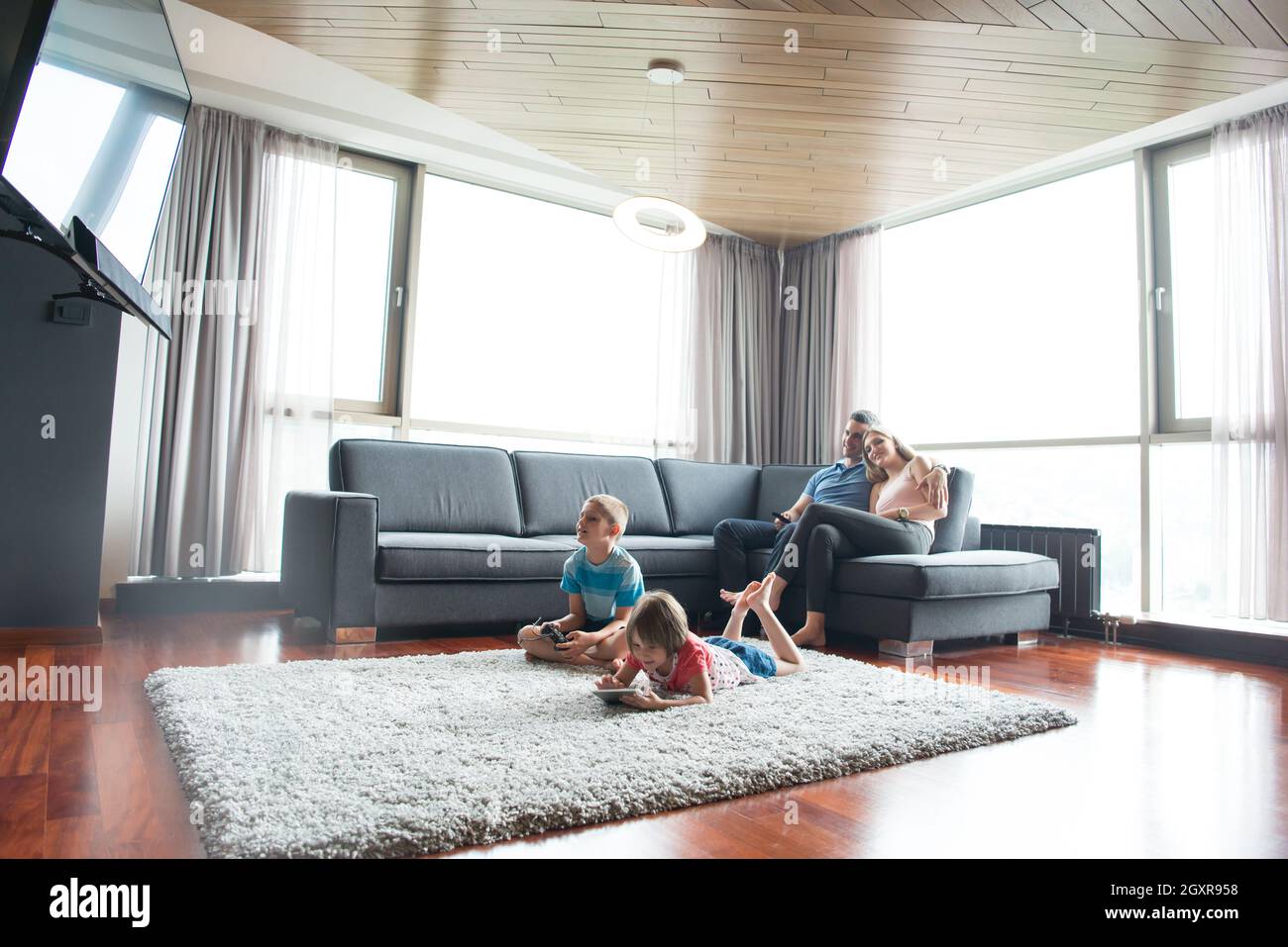 Happy Young Family Playing Together at home Stock Photo - Alamy