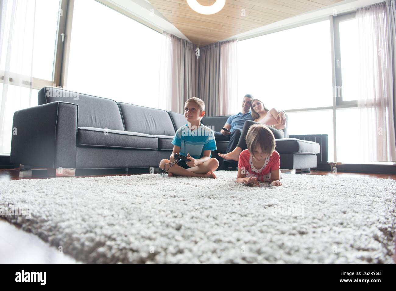 Happy Young Family Playing Together at home Stock Photo - Alamy