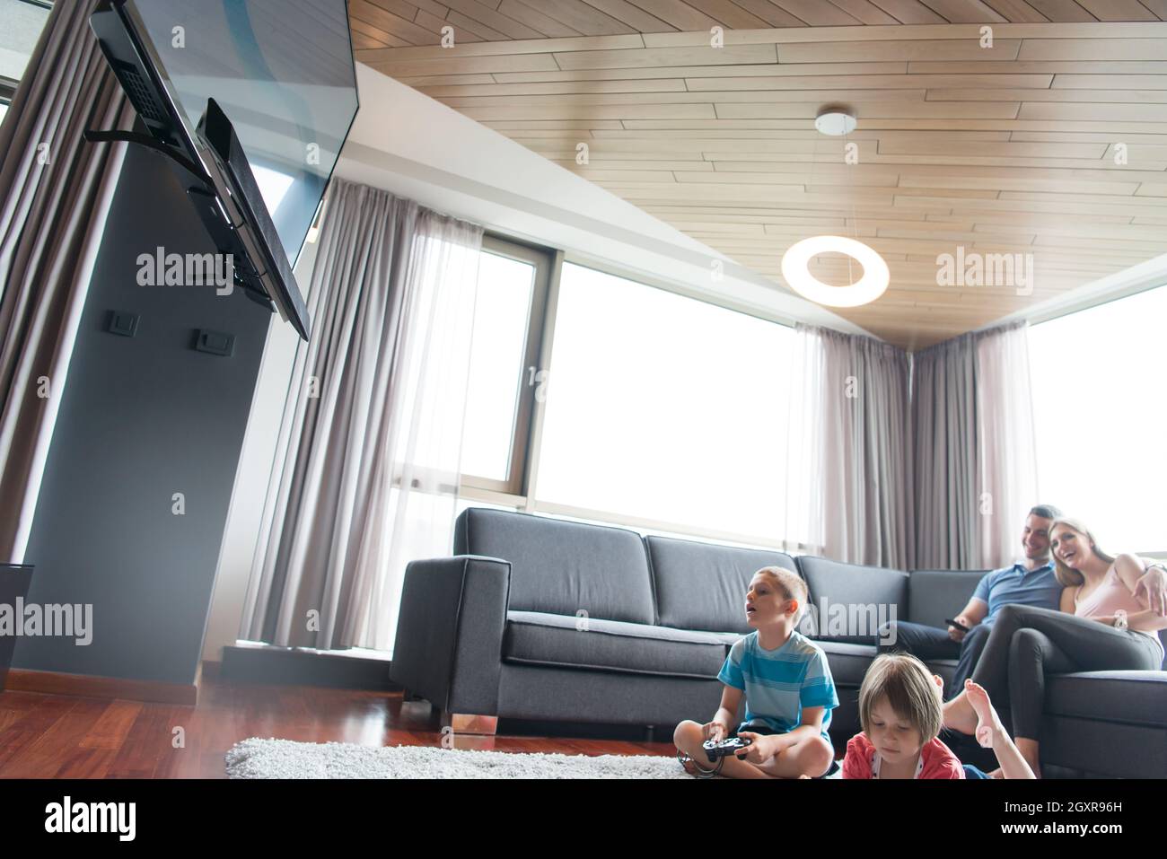 Happy Young Family Playing Together at home Stock Photo - Alamy