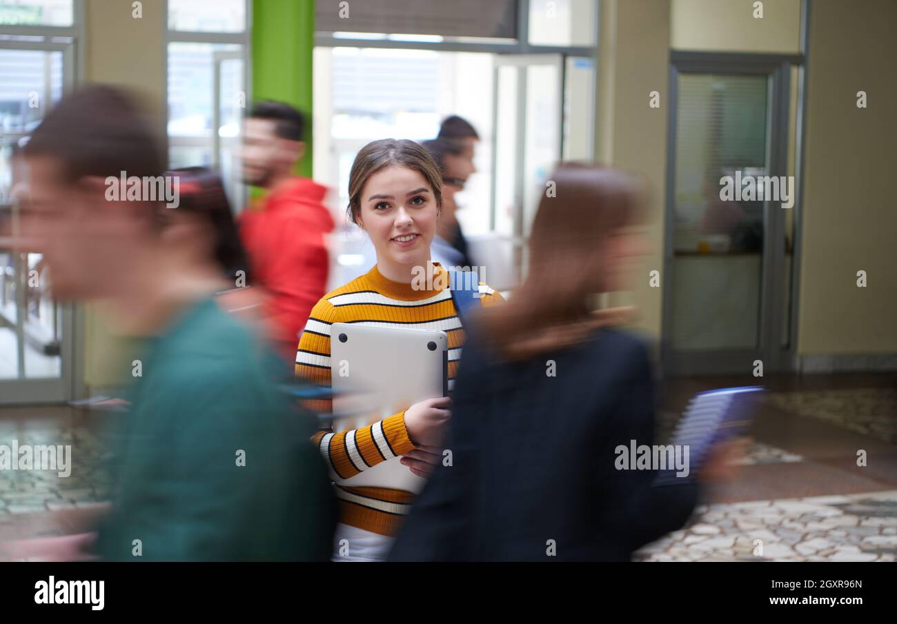 portrait of a happy young student getting ready for class while waiting ...