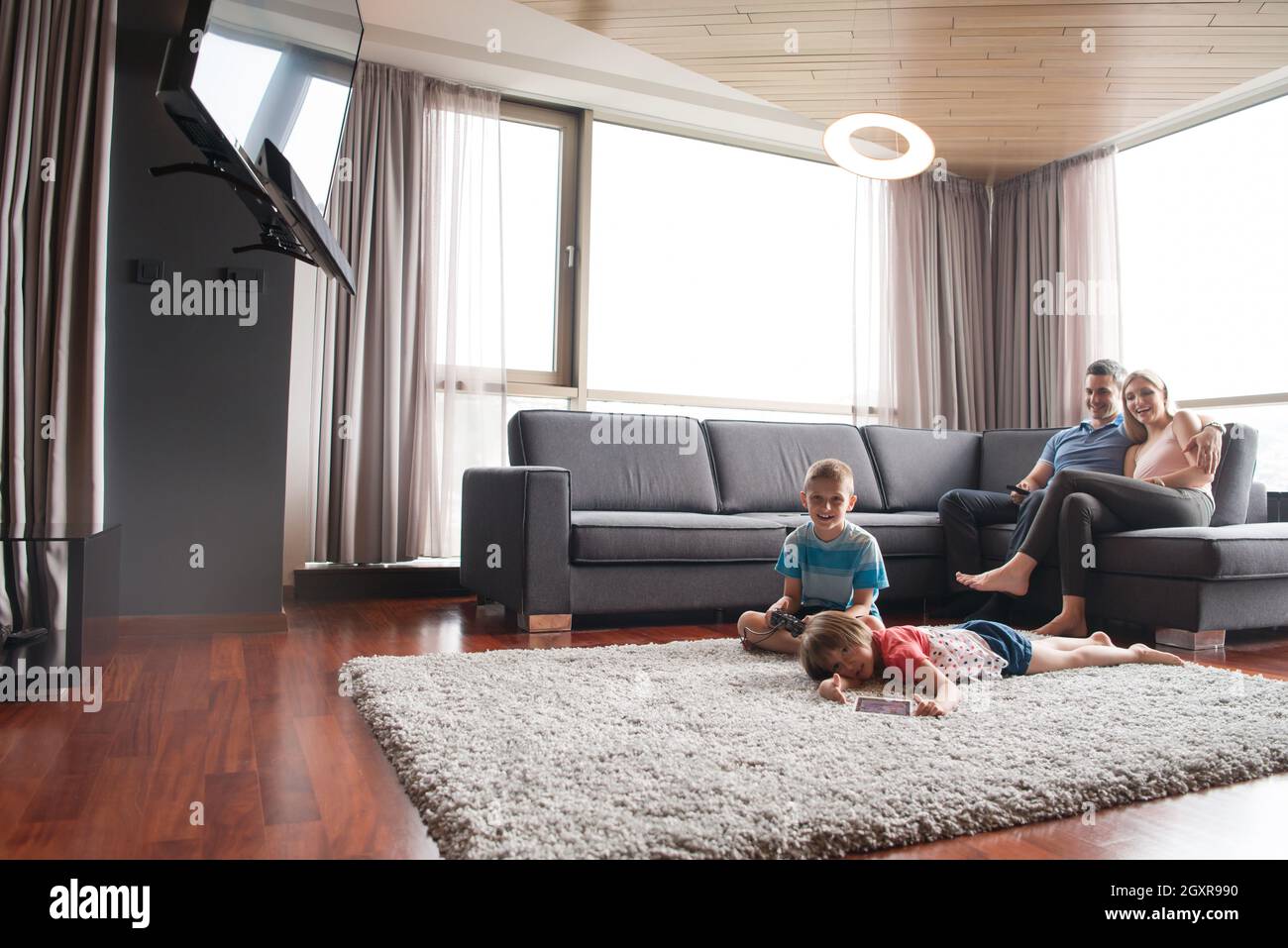 Happy Young Family Playing Together at home Stock Photo - Alamy