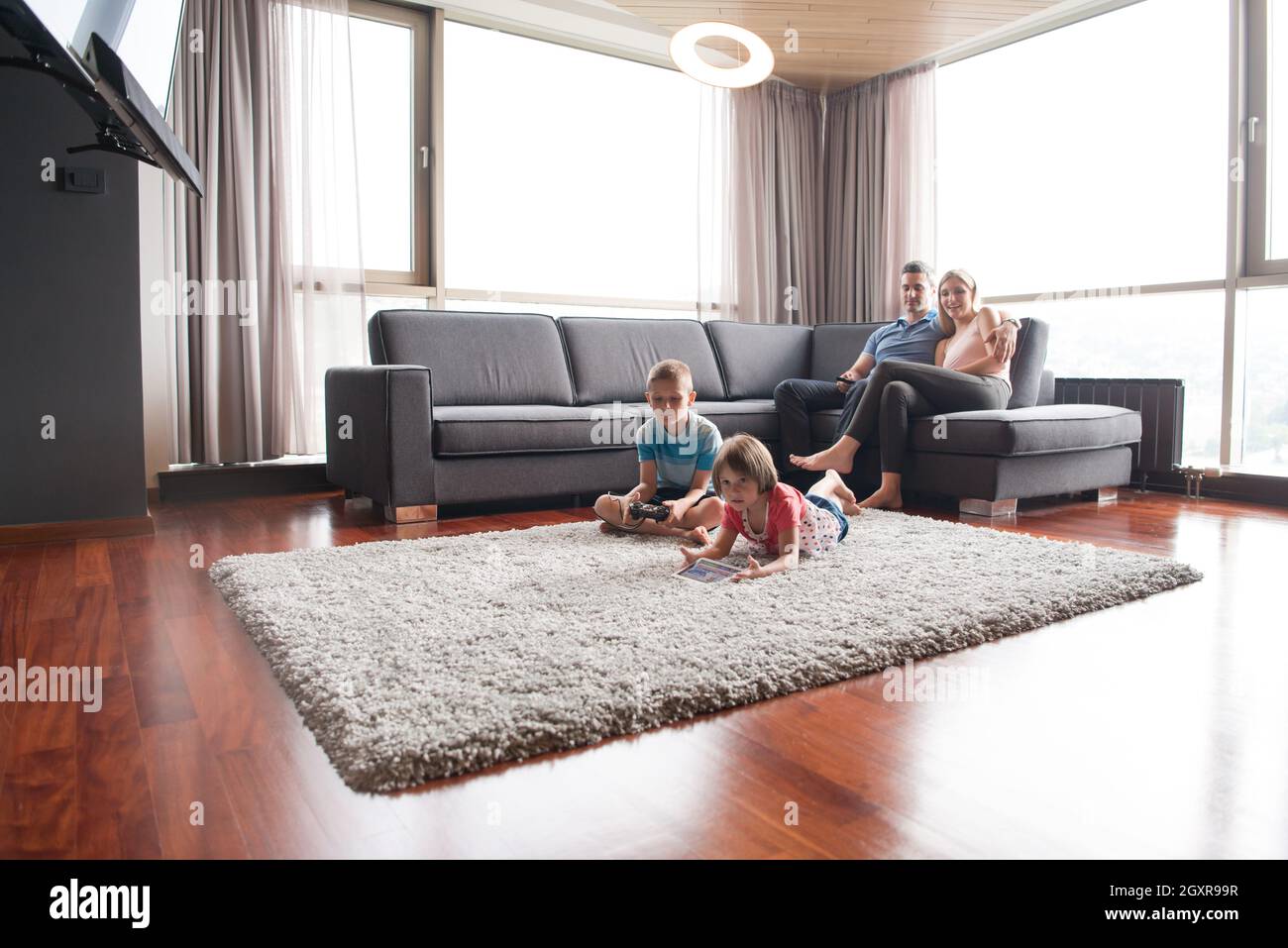 Happy Young Family Playing Together at home Stock Photo - Alamy