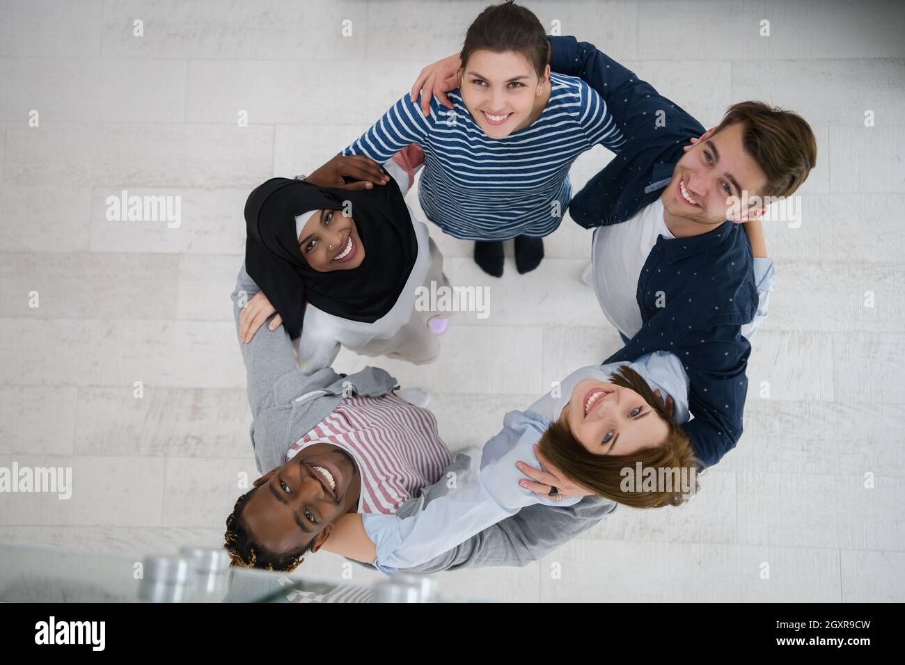 a top view of diverse group of people standing embracing and ...
