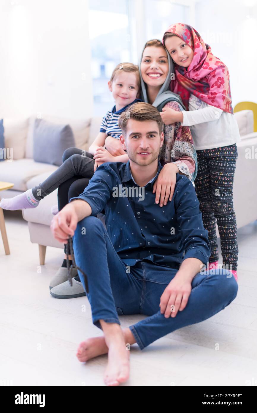 portrait of young happy modern muslim family before iftar dinner during ...