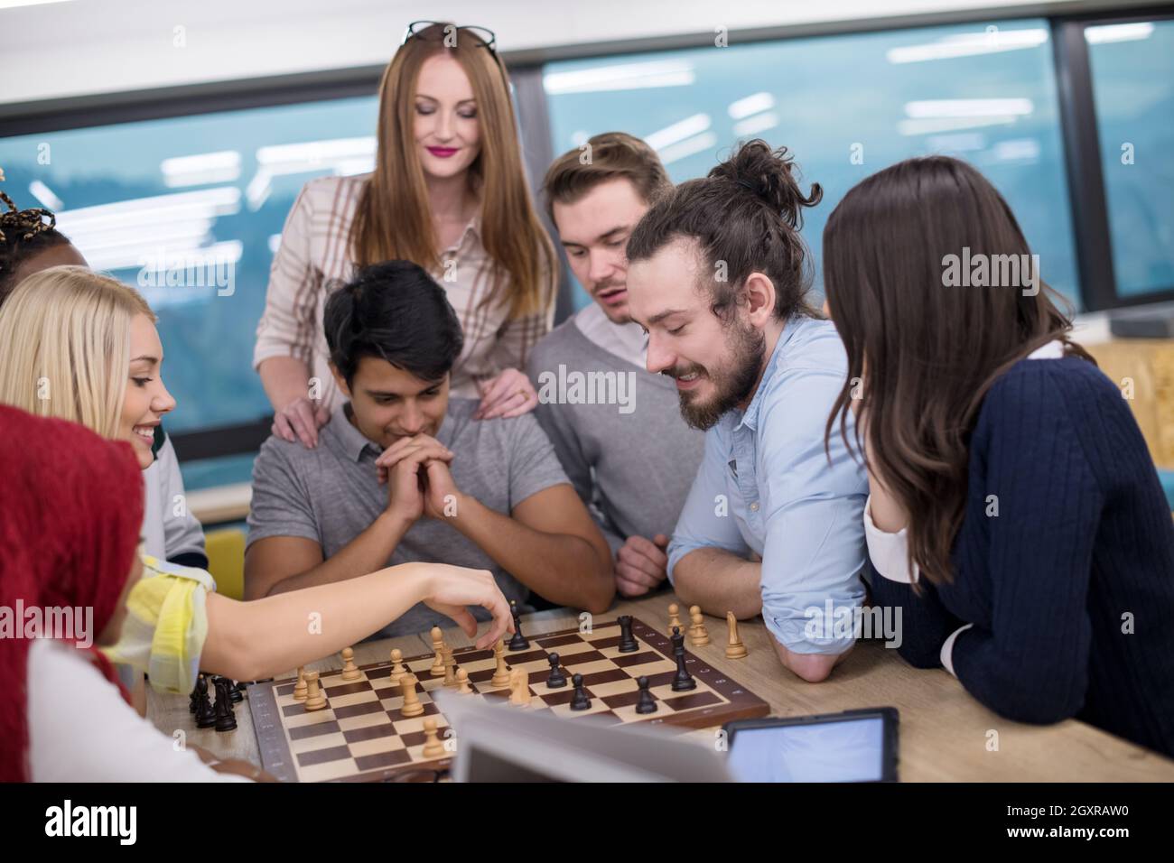 a multiethnic group of business people playing chess while having a ...