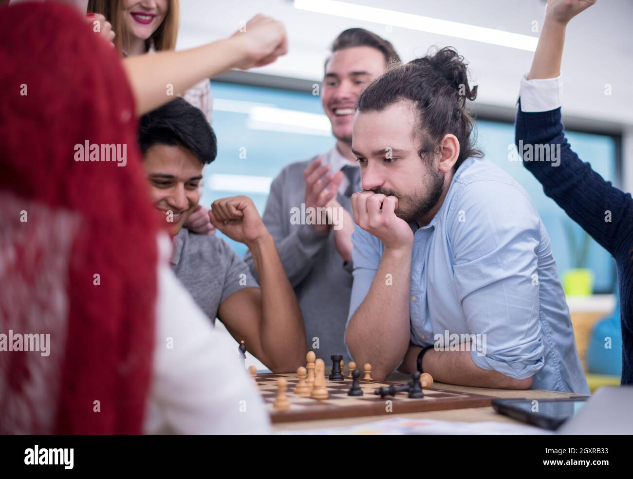 a multiethnic group of business people playing chess while having a ...