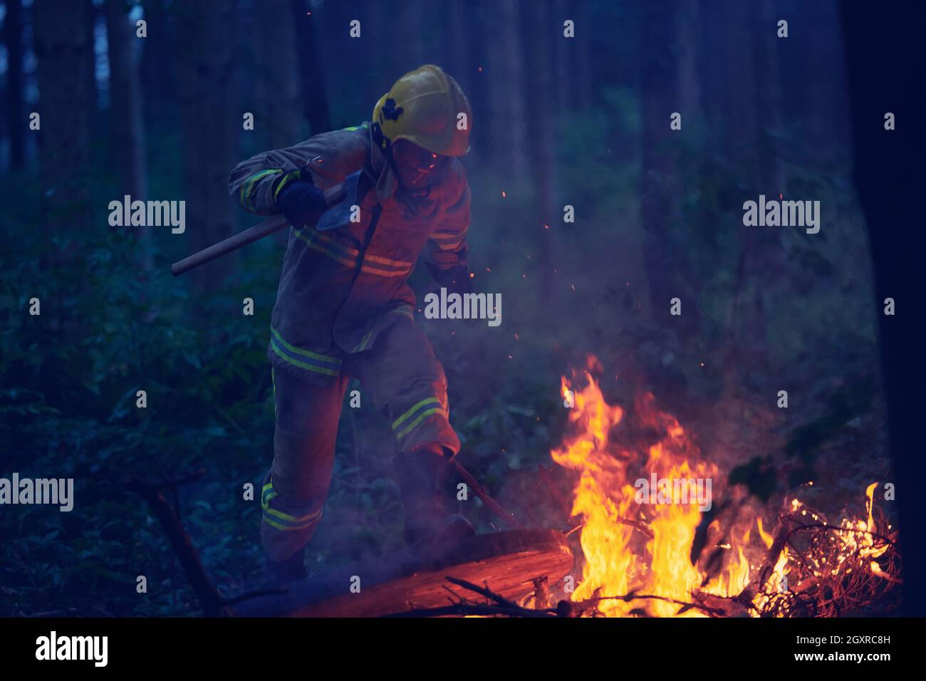 firefighter hero in action danger jumping over fire flame to rescue and ...