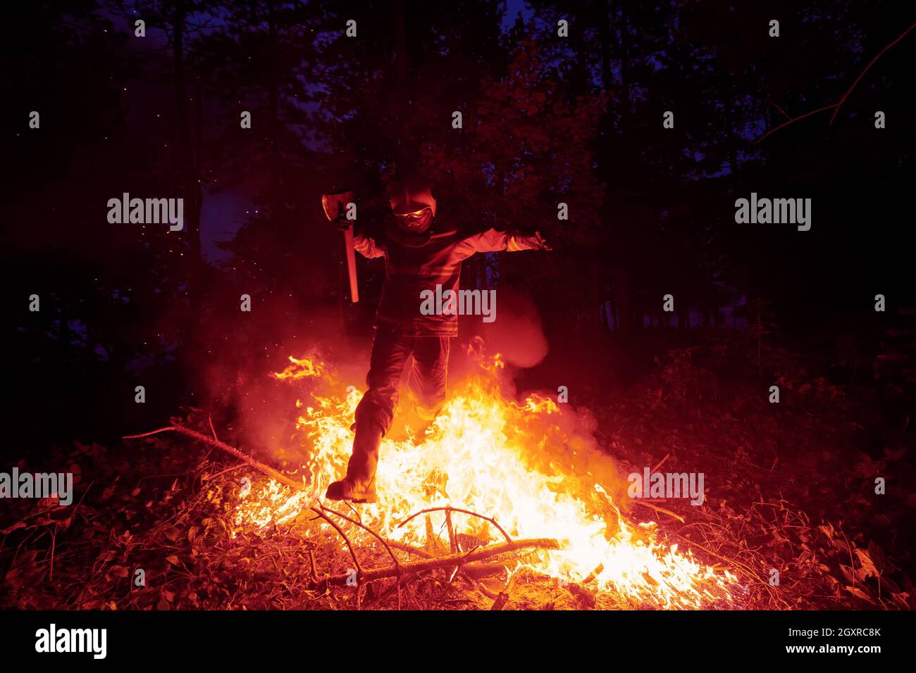 firefighter hero in action danger jumping over fire flame to rescue and ...