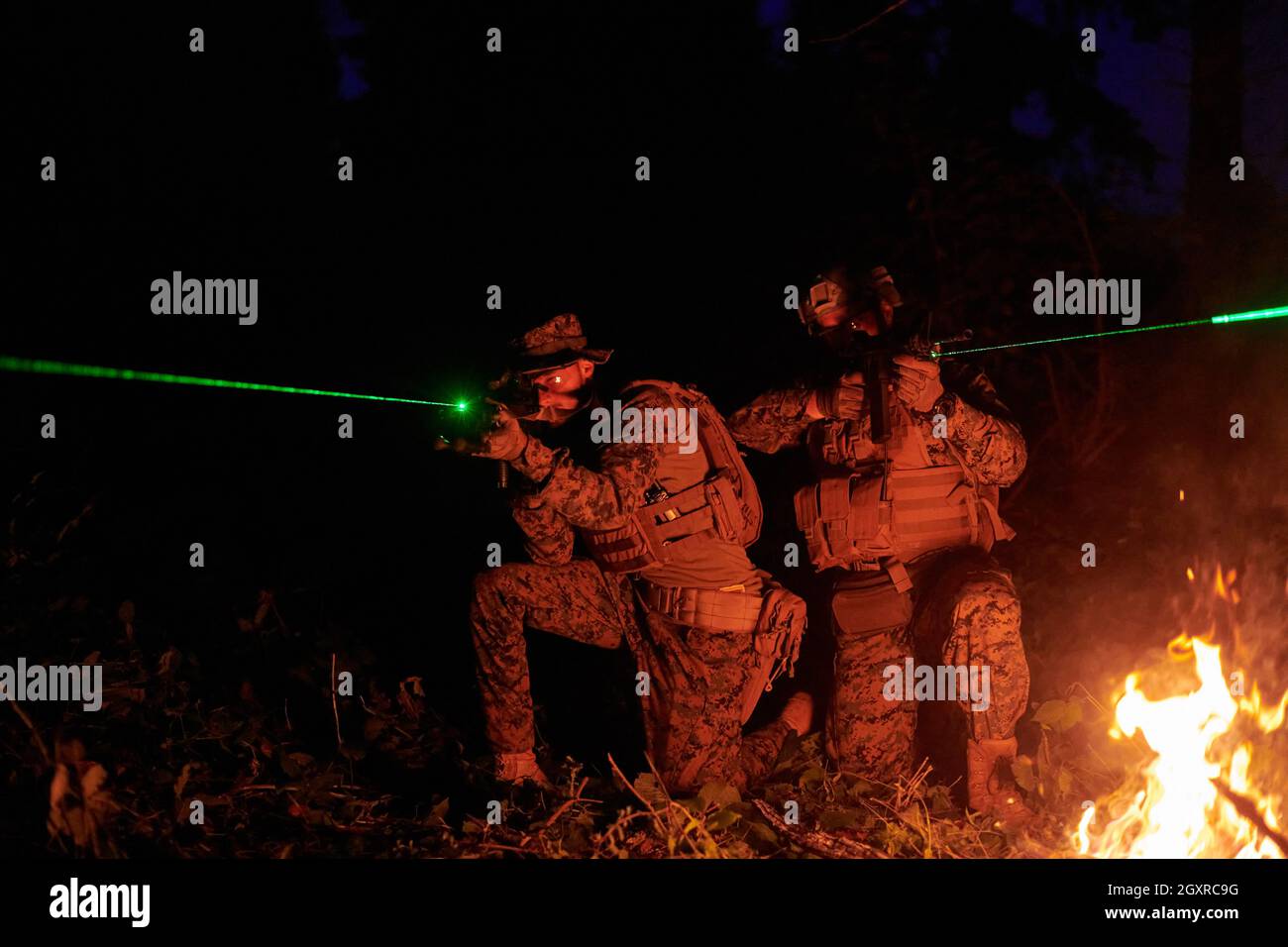 soldiers squad in action on night mission using laser sight beam lights ...