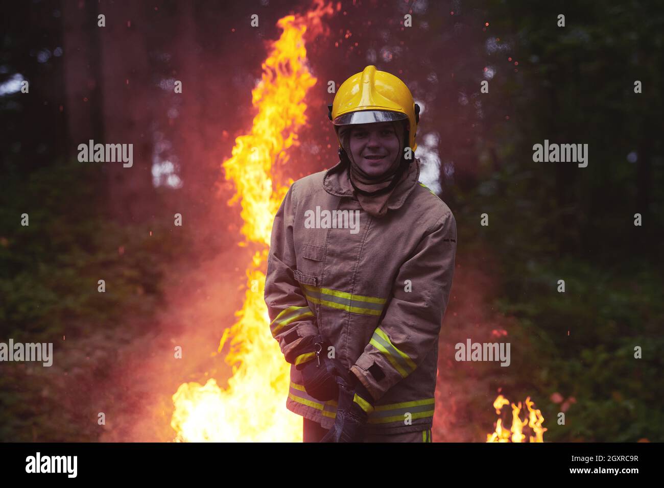 firefighter portrait on authentic fire location in forest Stock Photo ...