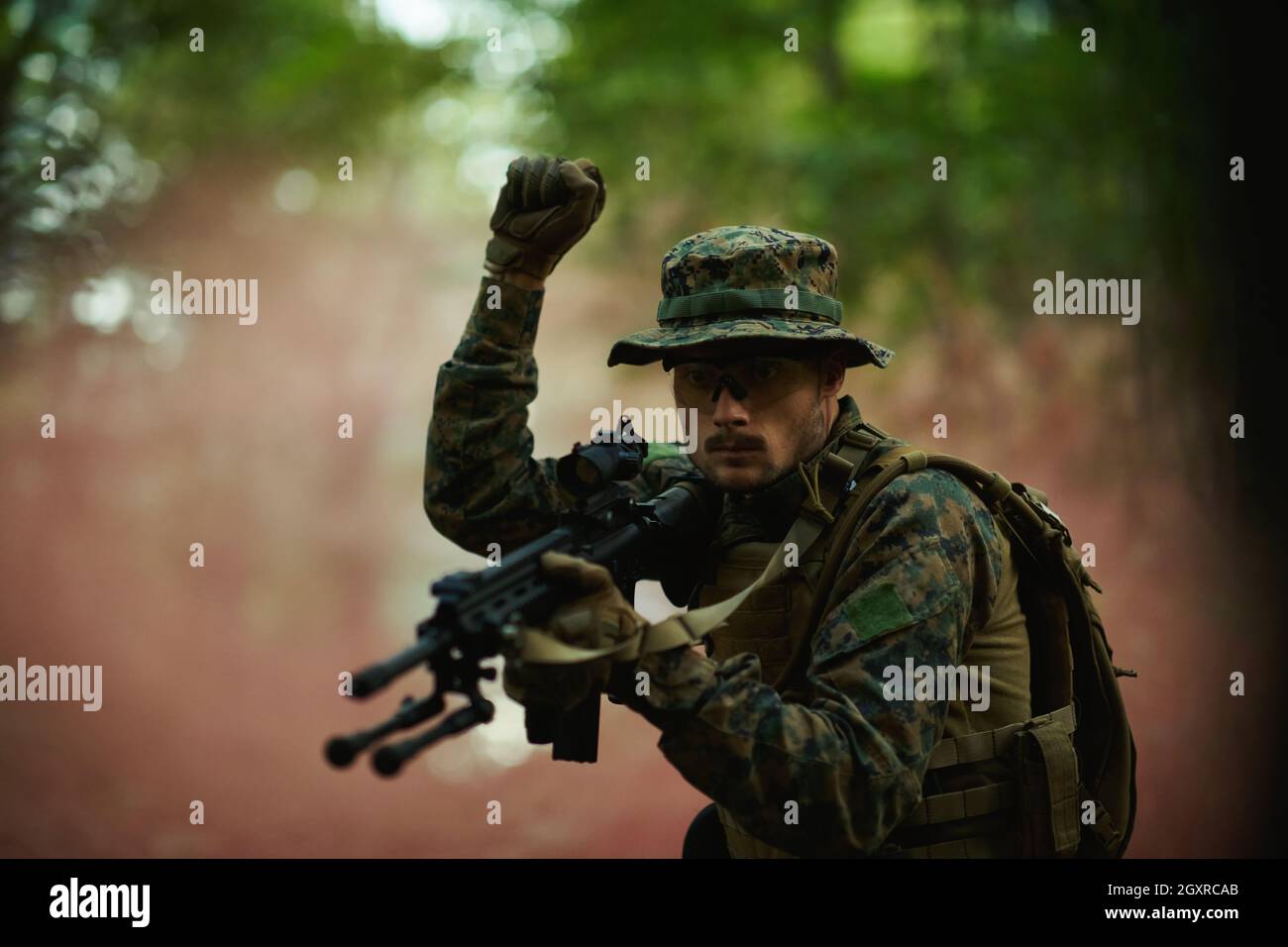 modern warfare soldier officer is showing tactical hand signals to ...