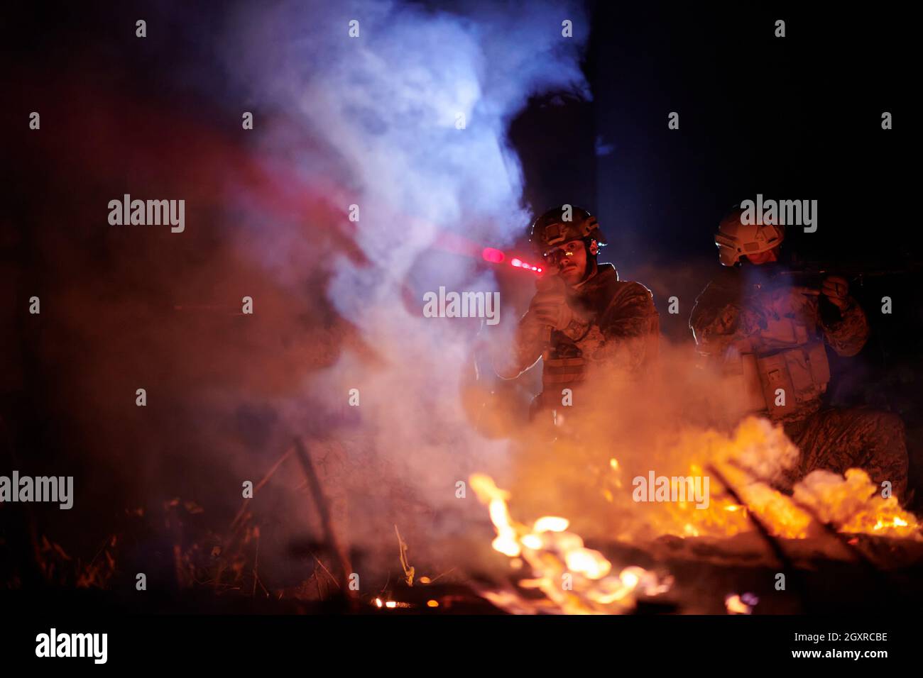 soldiers squad in action on night mission using laser sight beam lights ...