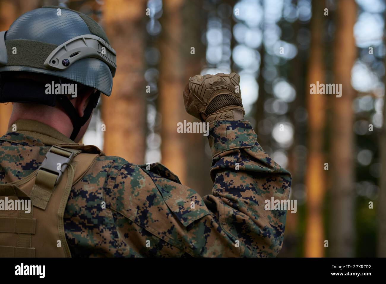 modern warfare soldier officer is showing tactical hand signals to ...
