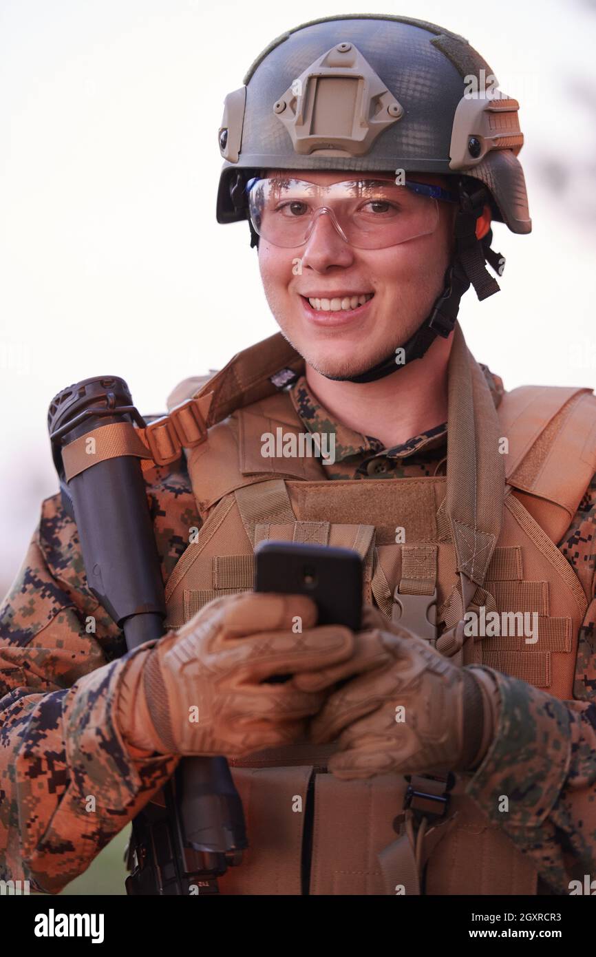 soldier using smart phone to contact family or girlfriend communication ...