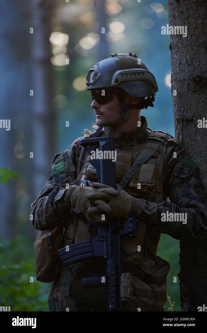 soldier portrait with protective army tactical gear and weapon having a ...