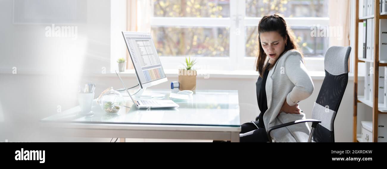 Bad Posture Sitting In Office With Backache In Chair Stock Photo - Alamy