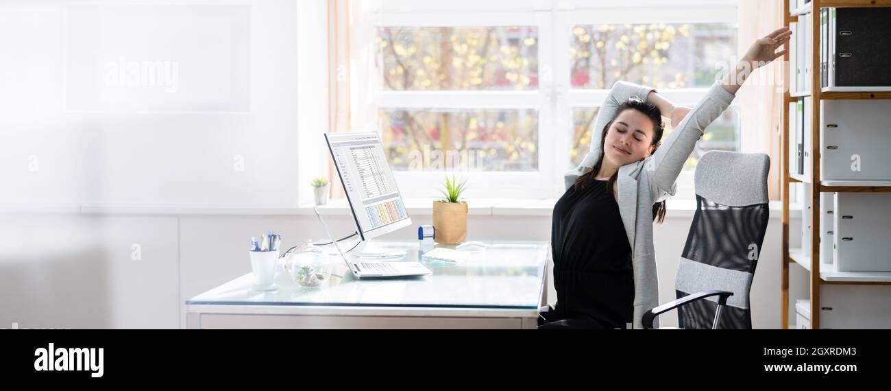 Stretch Exercise At Office Desk Near Computer Stock Photo - Alamy