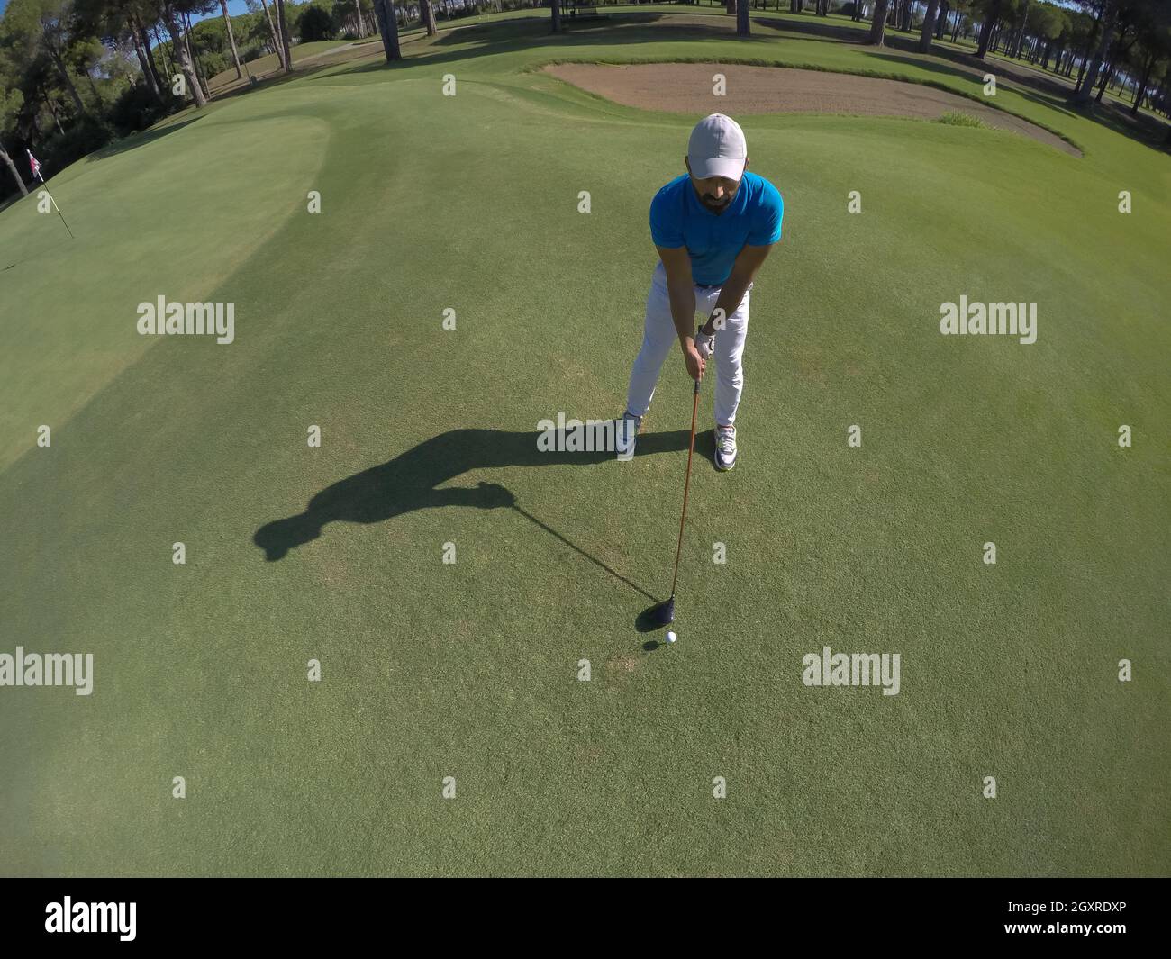 top view of golf player hitting shot with club on course at beautiful ...