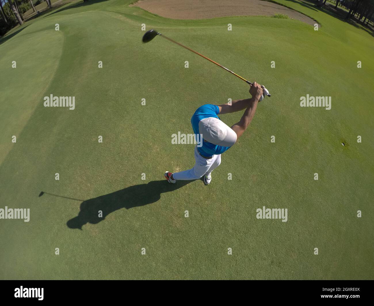 top view of golf player hitting shot with club on course at beautiful ...