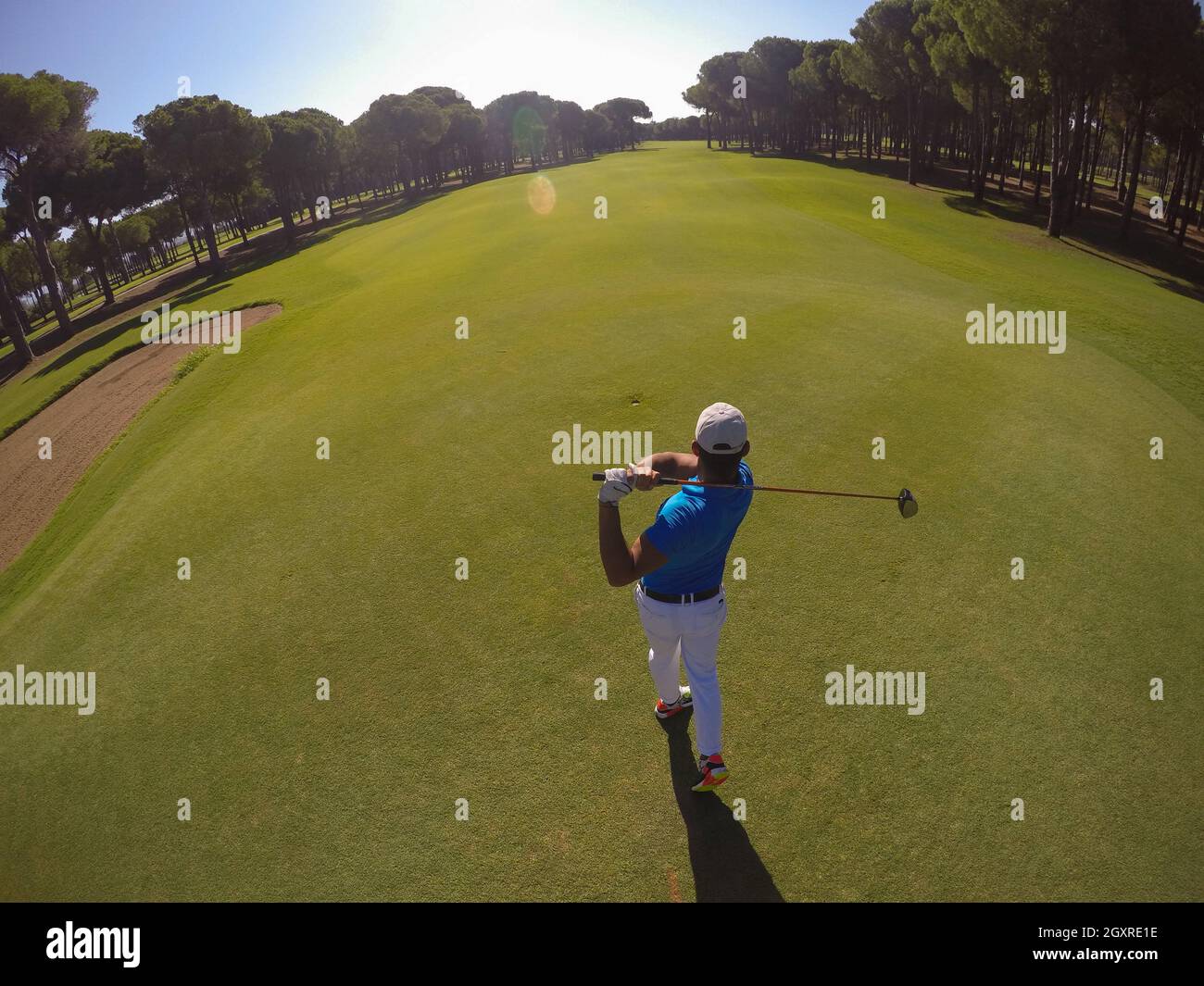 top view of golf player hitting shot with club on course at beautiful ...