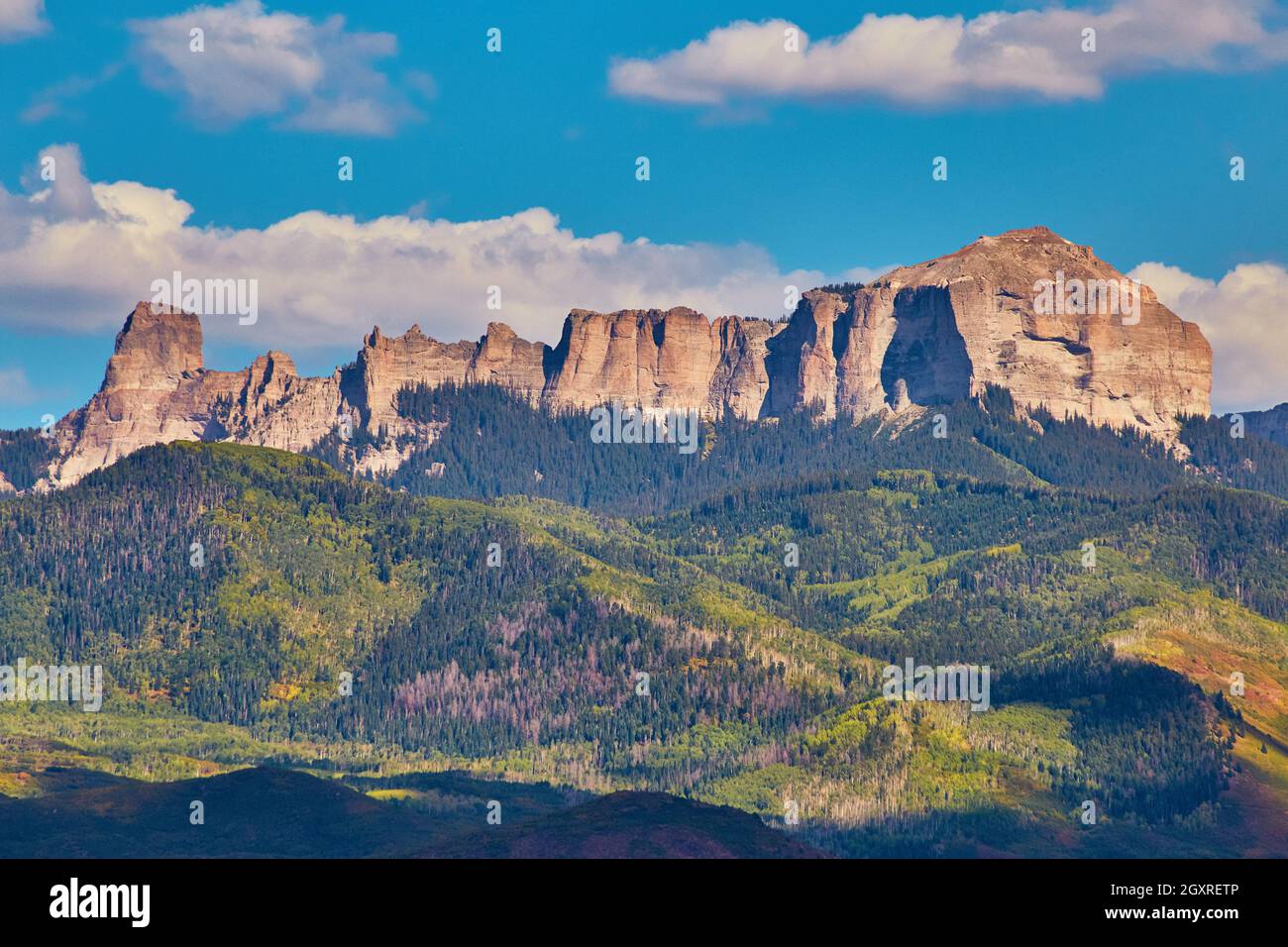 Large cliff rock mountains out of lush green forest Stock Photo - Alamy