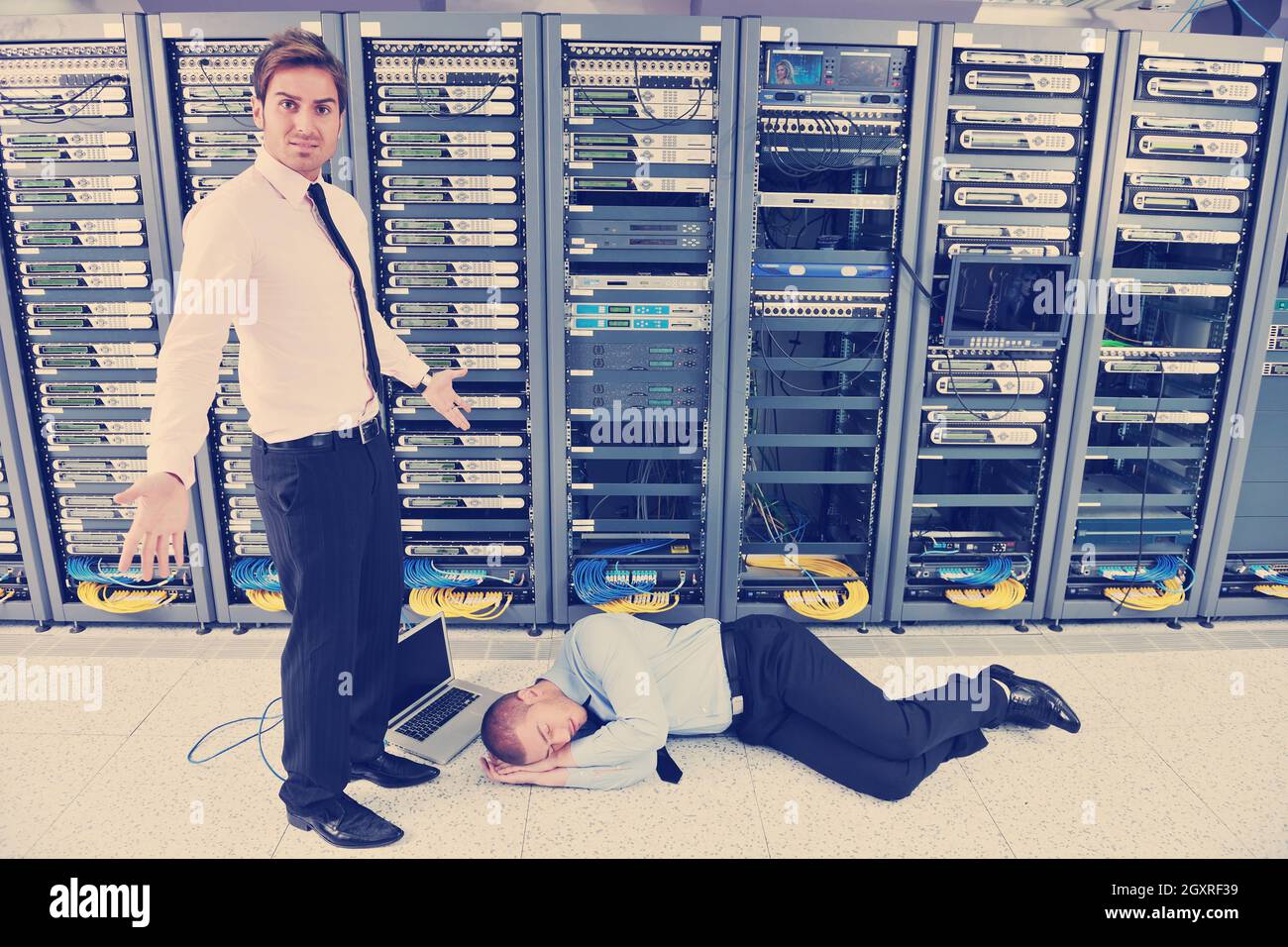 it business man in network server room have problems and looking for ...