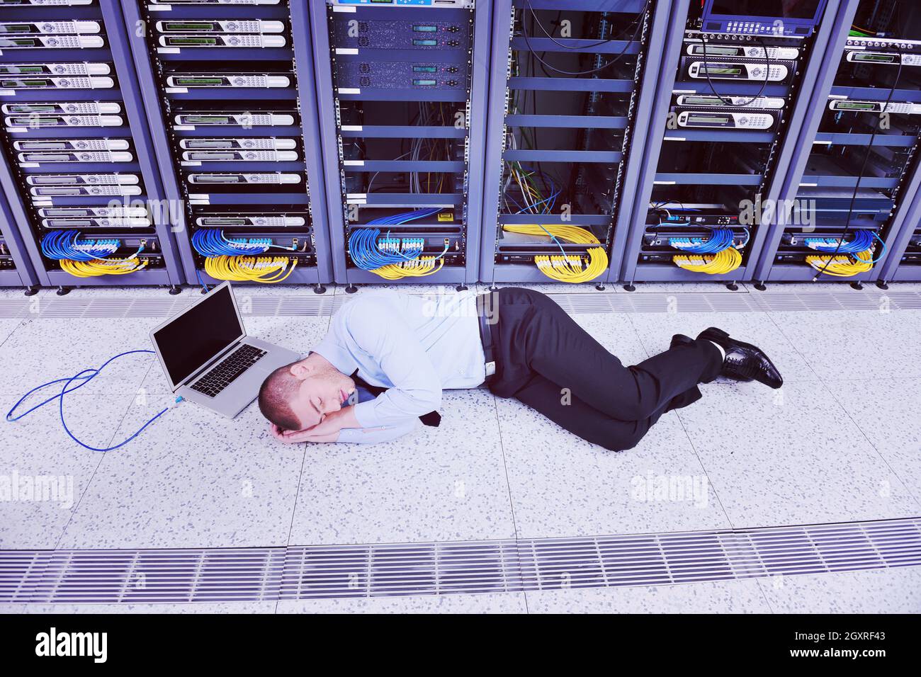 it business man in network server room have problems and looking for ...