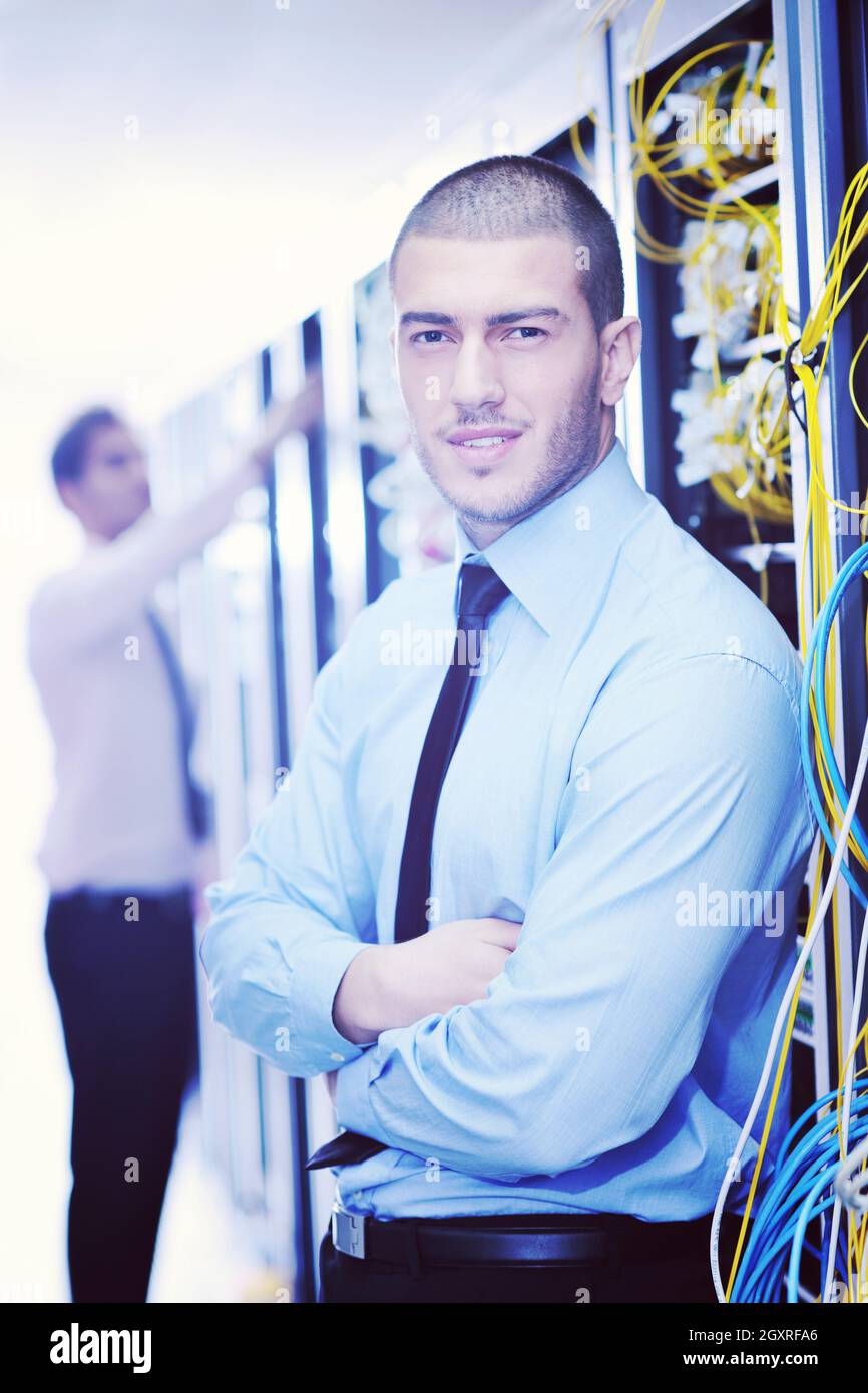 group of young business people it engineer in network server room solving problems and give help ...