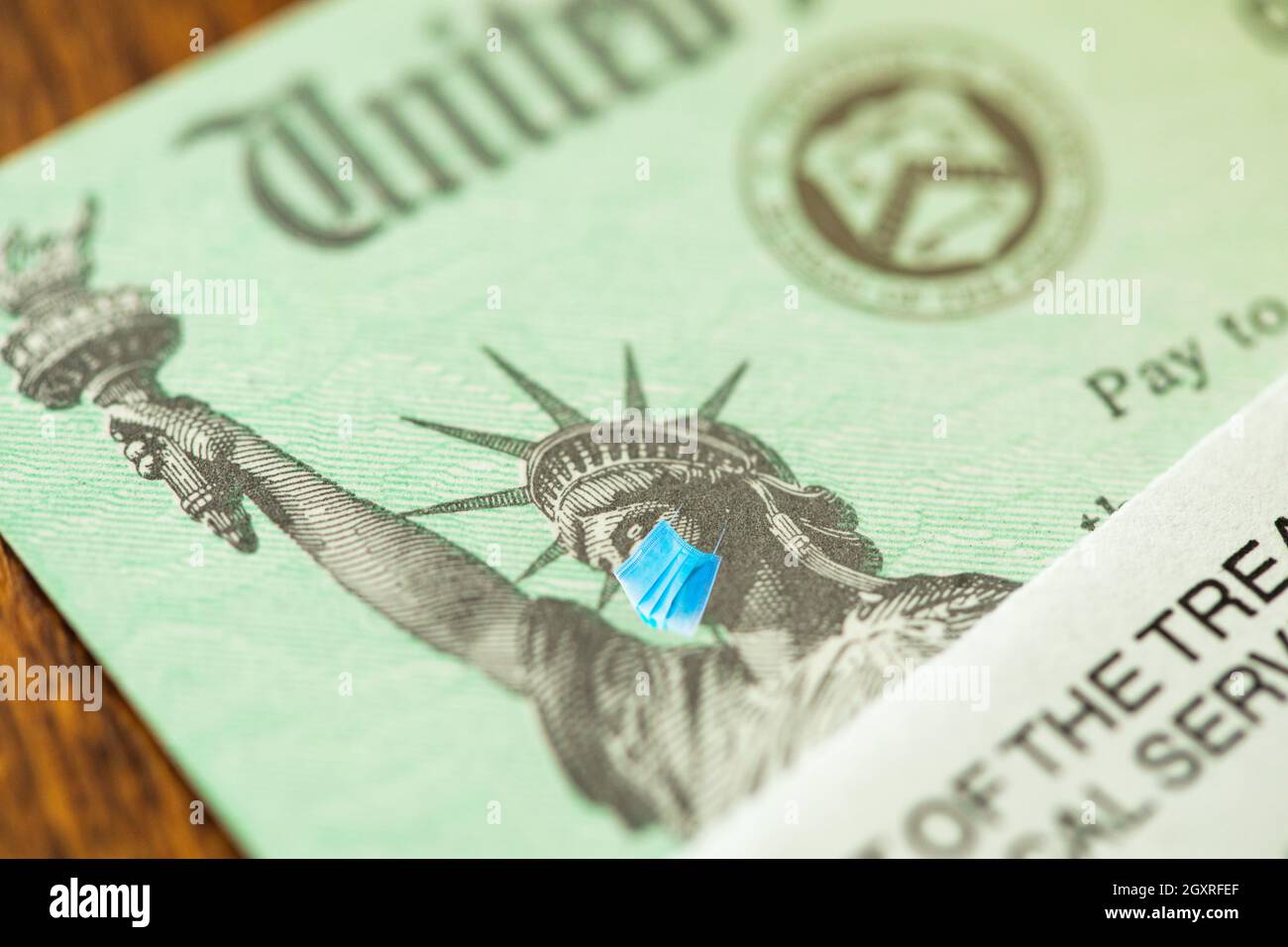 United States IRS Stimulus Check with Statue of Liberty Wearing Medical ...