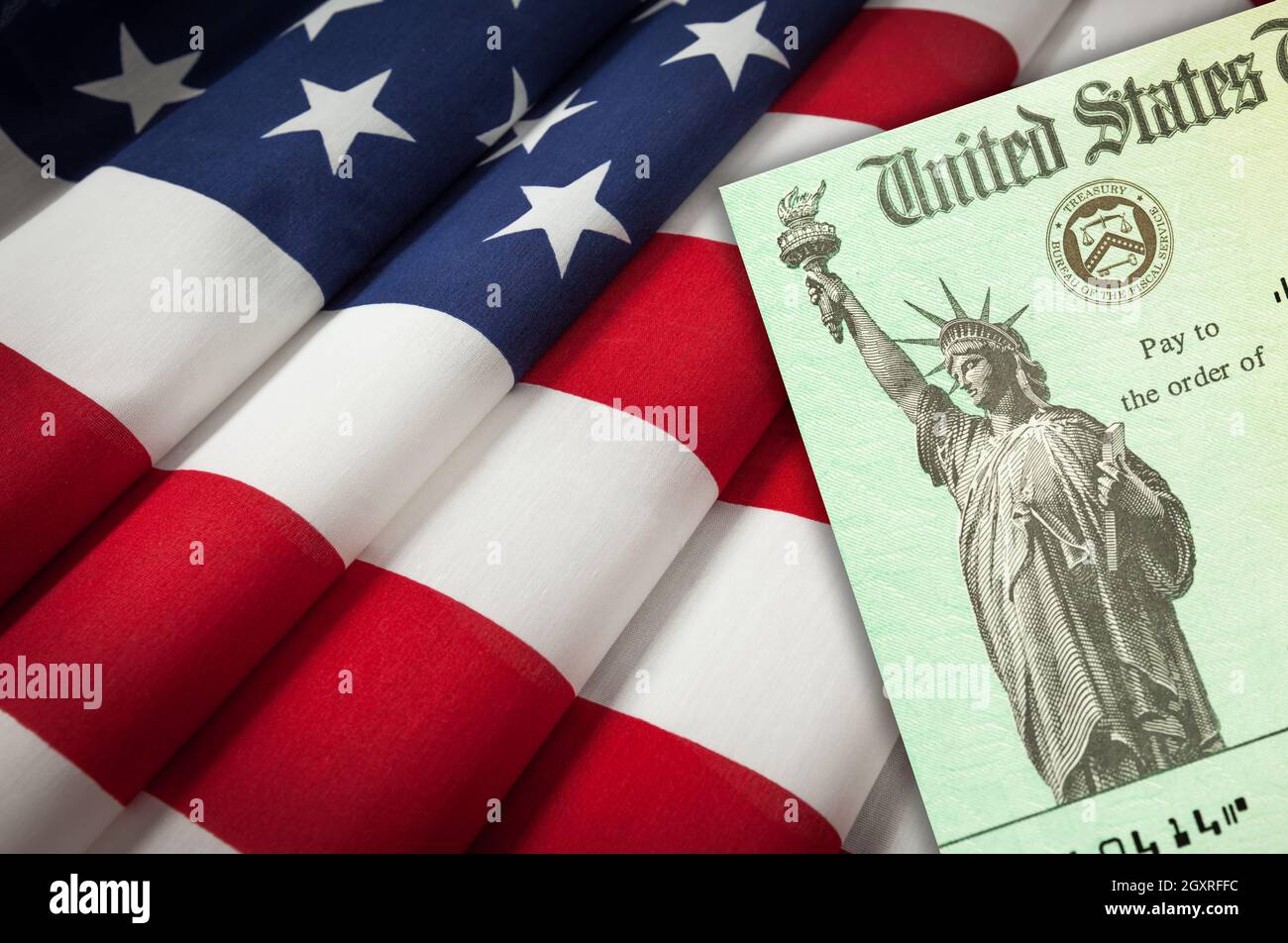 United States IRS Stimulus Check Resting on American Flag Stock Photo ...