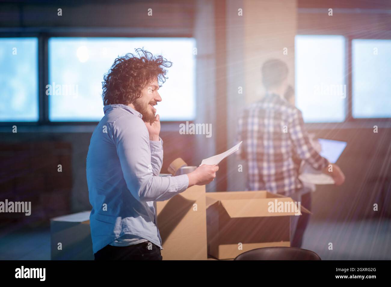 young male architect on construction site checking documents and ...
