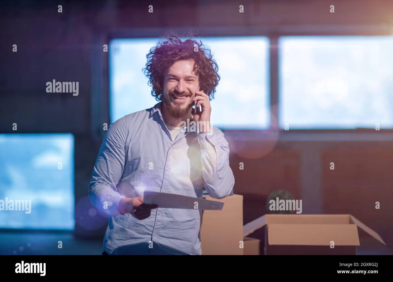young male architect on construction site checking documents and ...