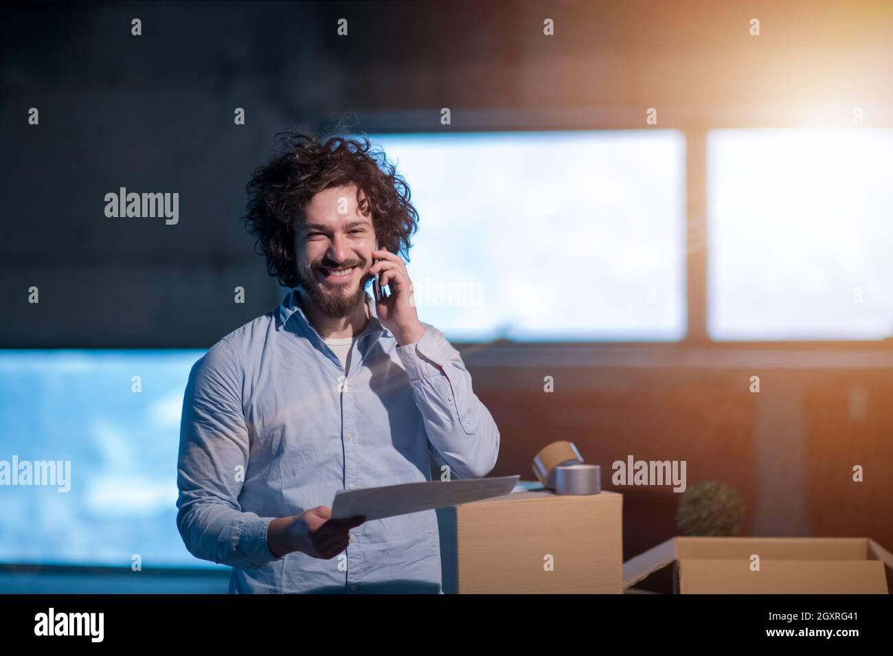 young male architect on construction site checking documents and ...
