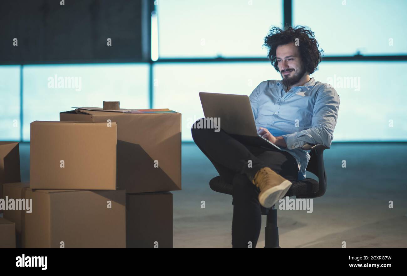 young male architect on construction site checking documents and ...