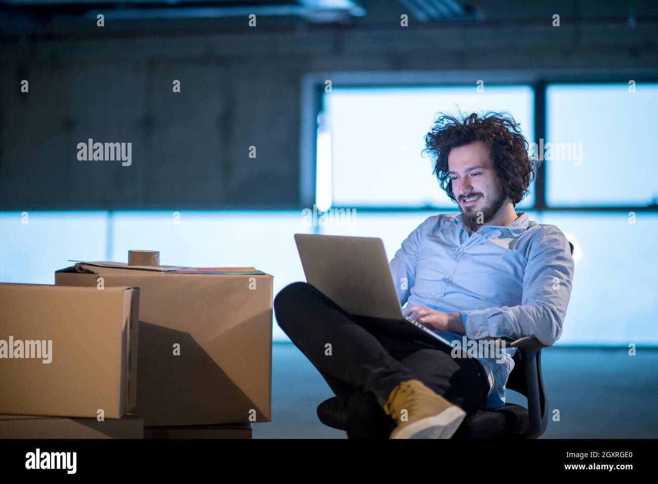 young male architect on construction site checking documents and ...