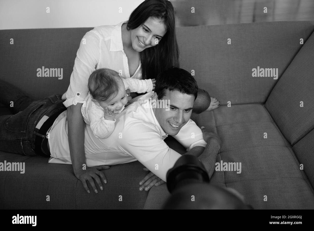 happy young family couple with beautiful new born baby have fun at ...