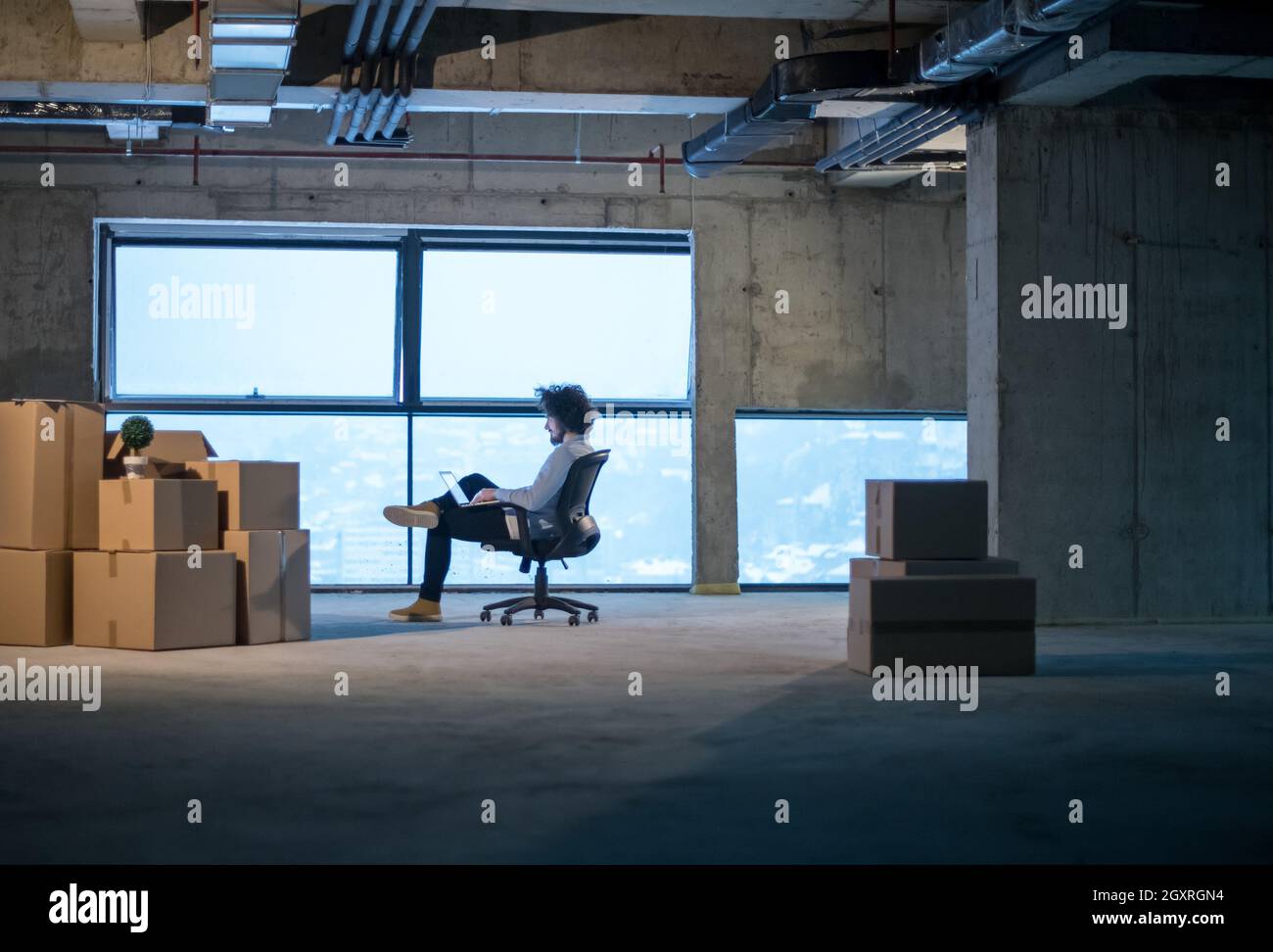 young male architect on construction site checking documents and ...