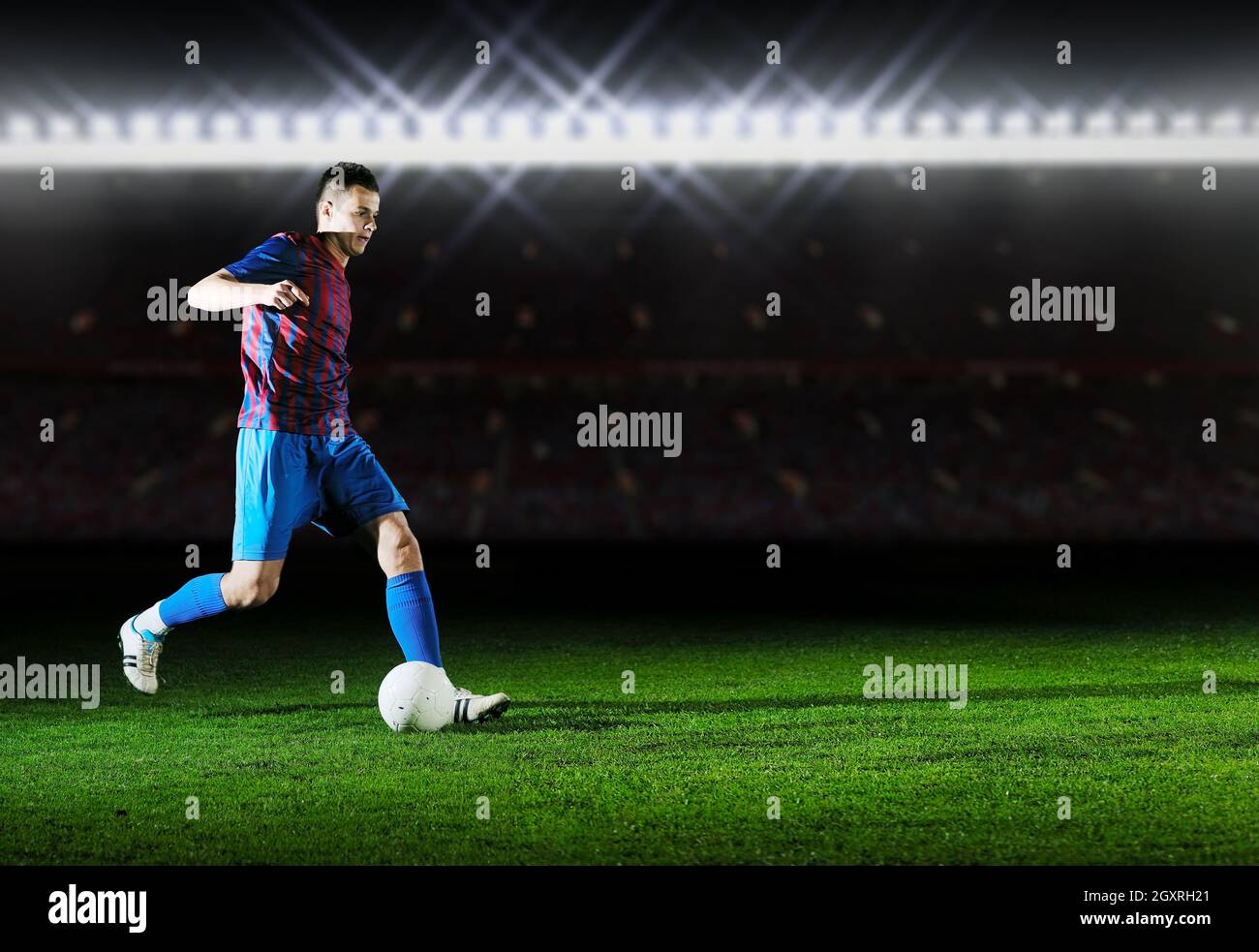 soccer player doing kick with ball on football stadium Stock Photo - Alamy