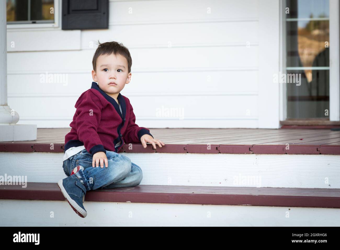 Cute Melancholy Mixed Race Boy Sitting on Front Porch Steps Stock Photo ...