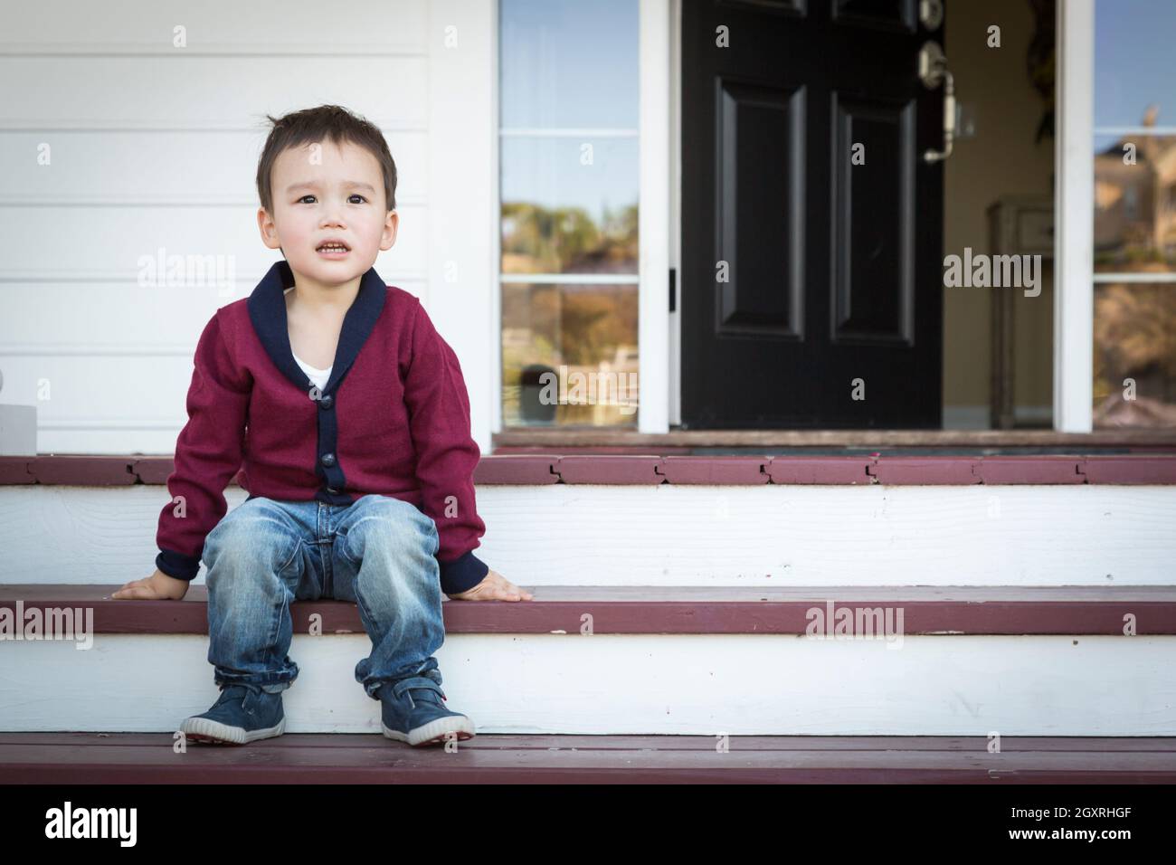 Cute Melancholy Mixed Race Boy Sitting on Front Porch Steps Stock Photo ...