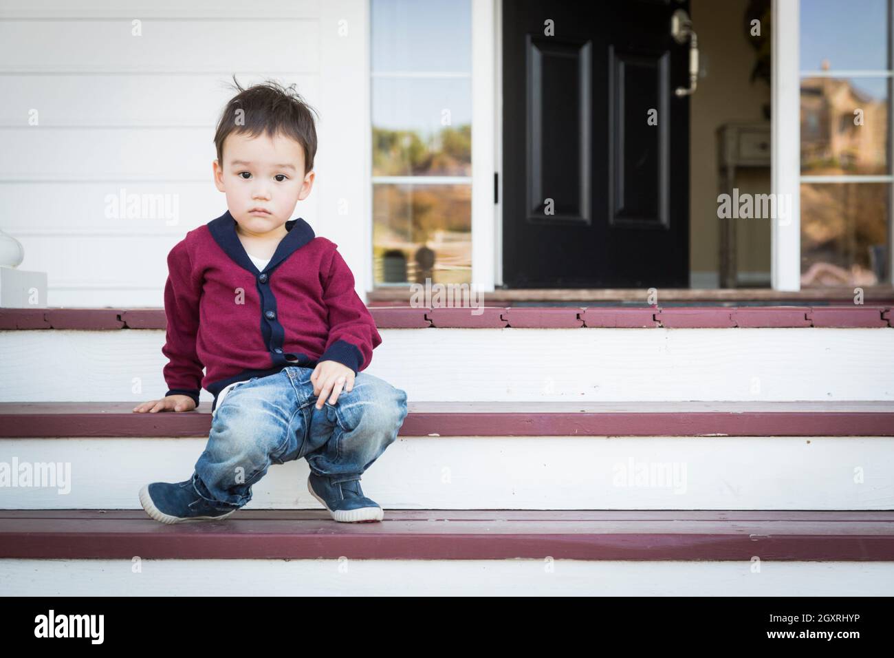 Cute Melancholy Mixed Race Boy Sitting on Front Porch Steps Stock Photo ...