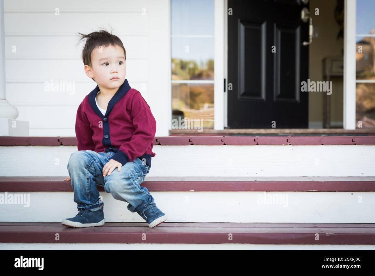 Cute Melancholy Mixed Race Boy Sitting on Front Porch Steps Stock Photo ...