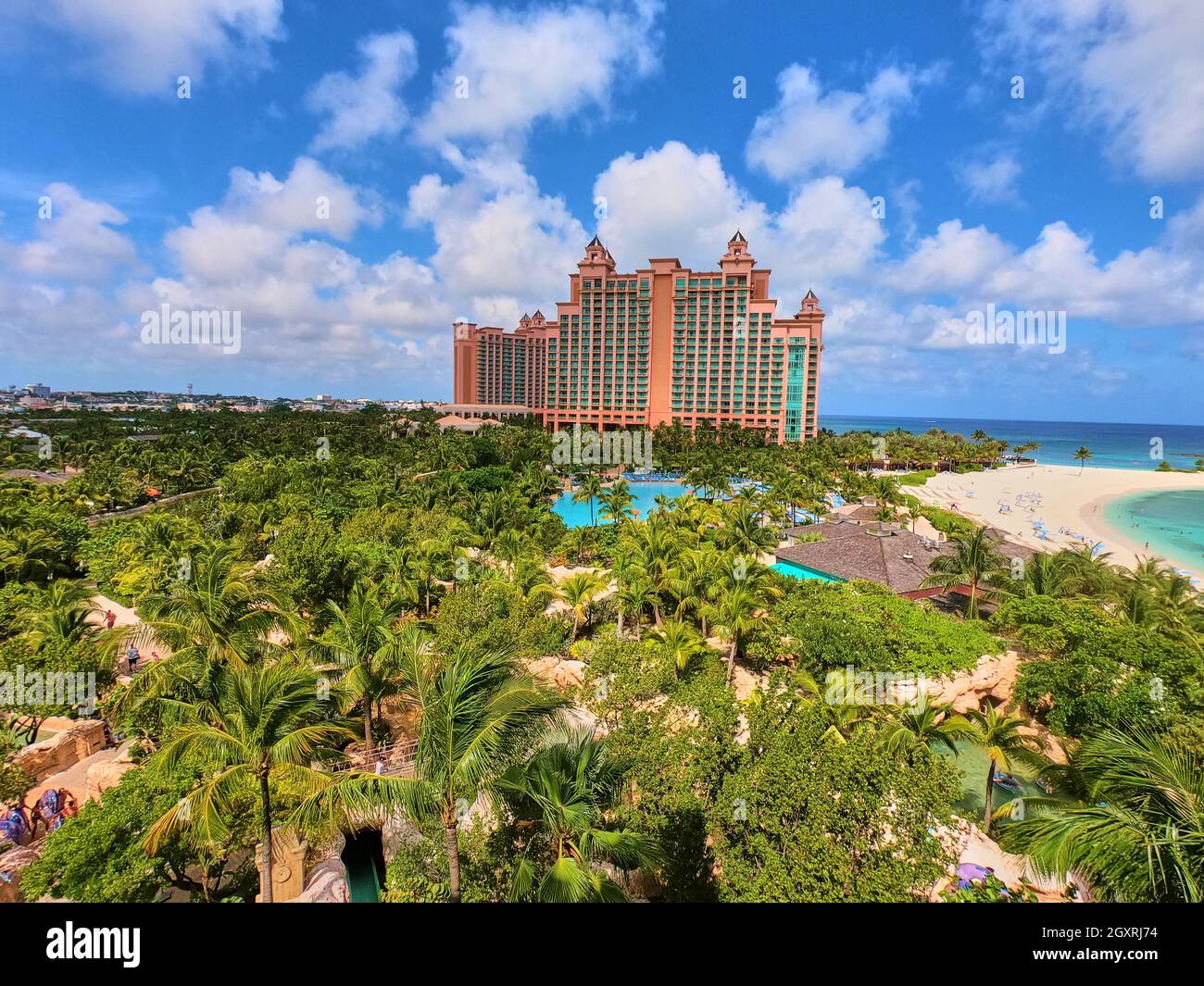 View high up of tropical resort with lush green gardens and sandy ...