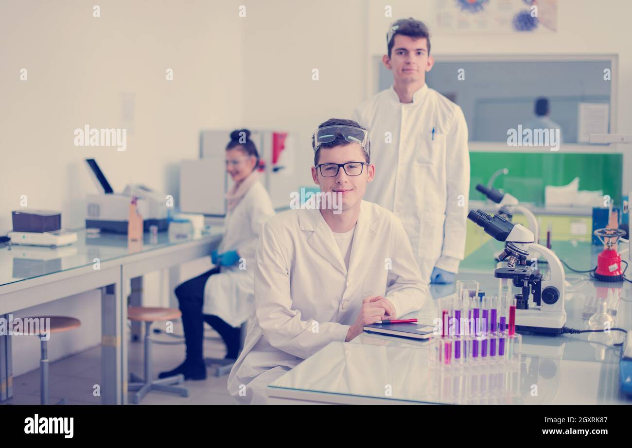Group of young medical students doing research together in chemistry ...