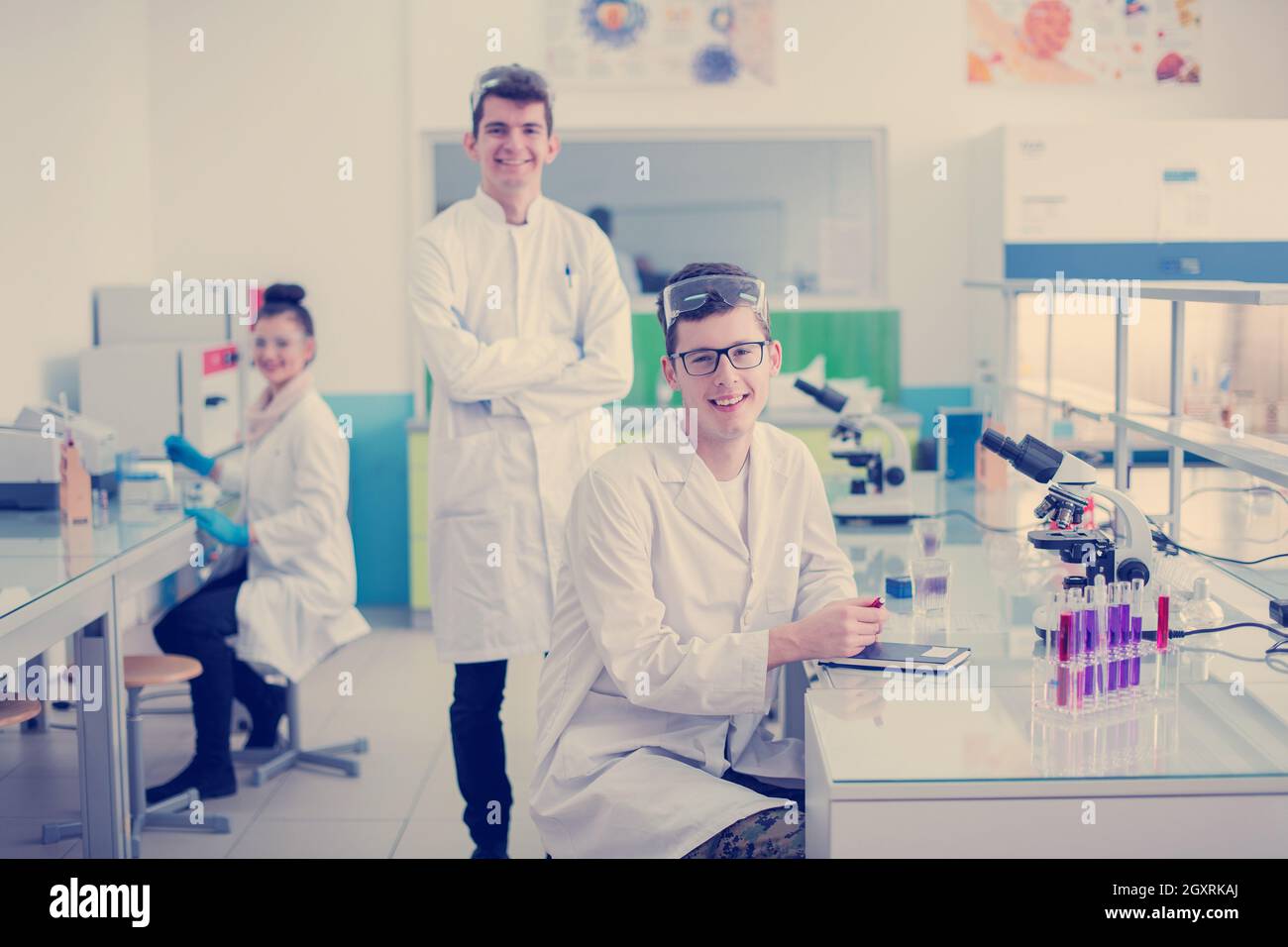 Group of young medical students doing research together in chemistry ...
