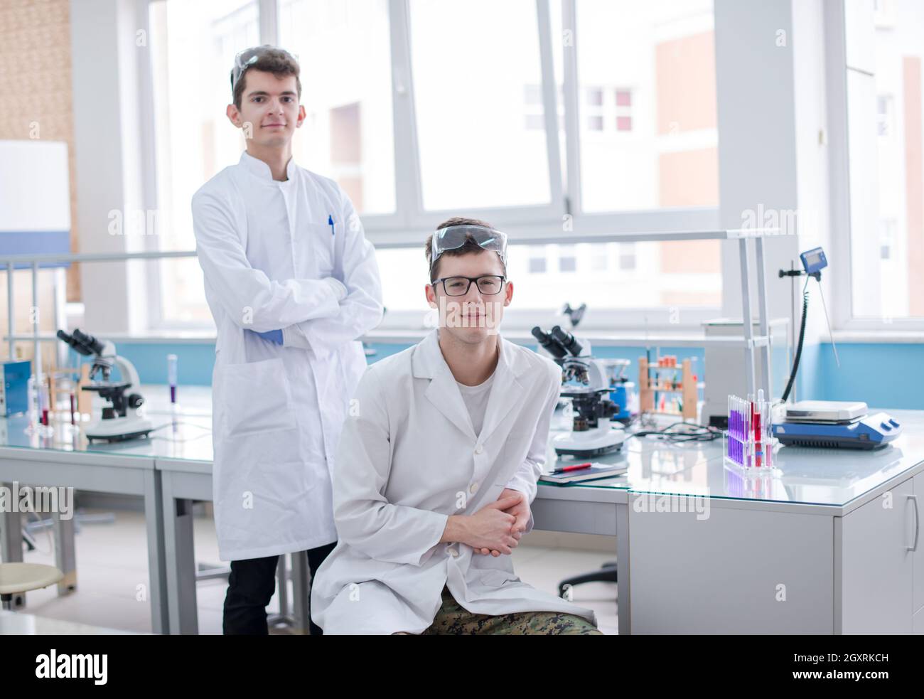 Group of young medical students doing research together in chemistry ...