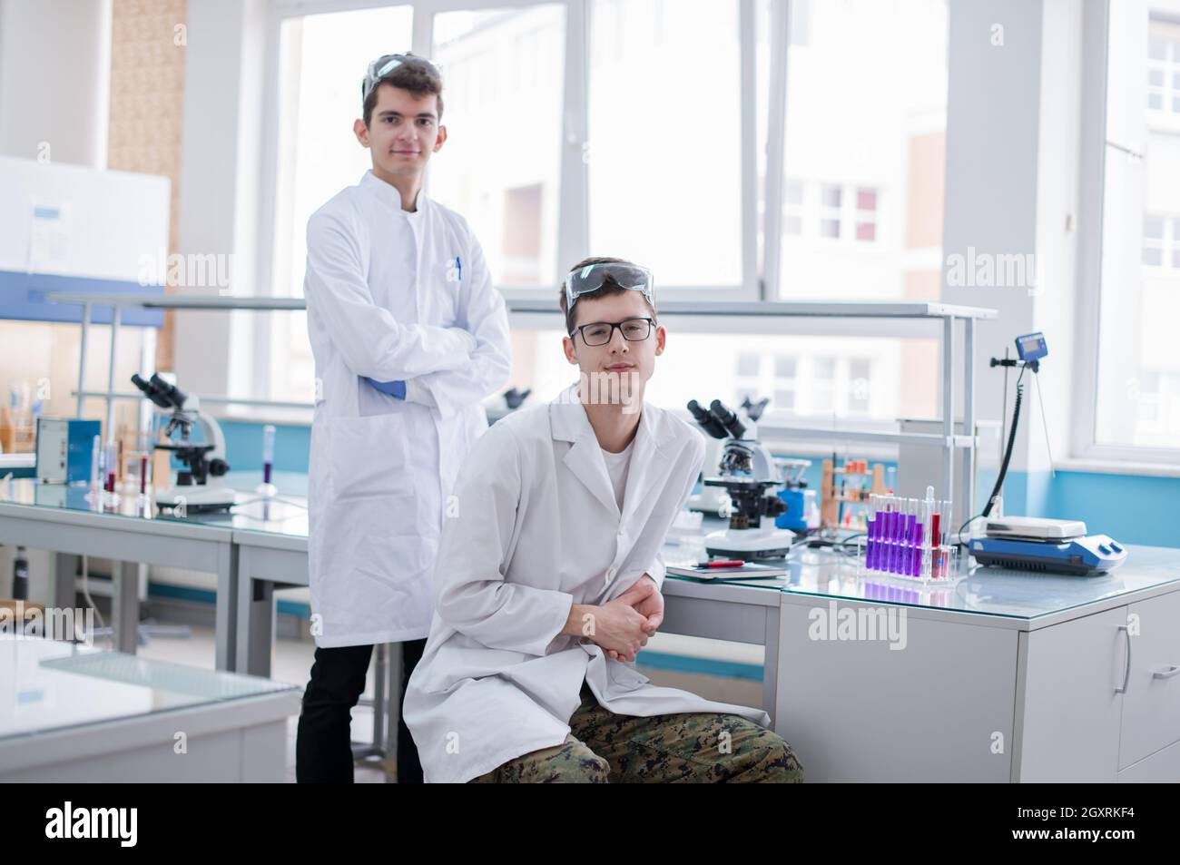 Group of young medical students doing research together in chemistry ...
