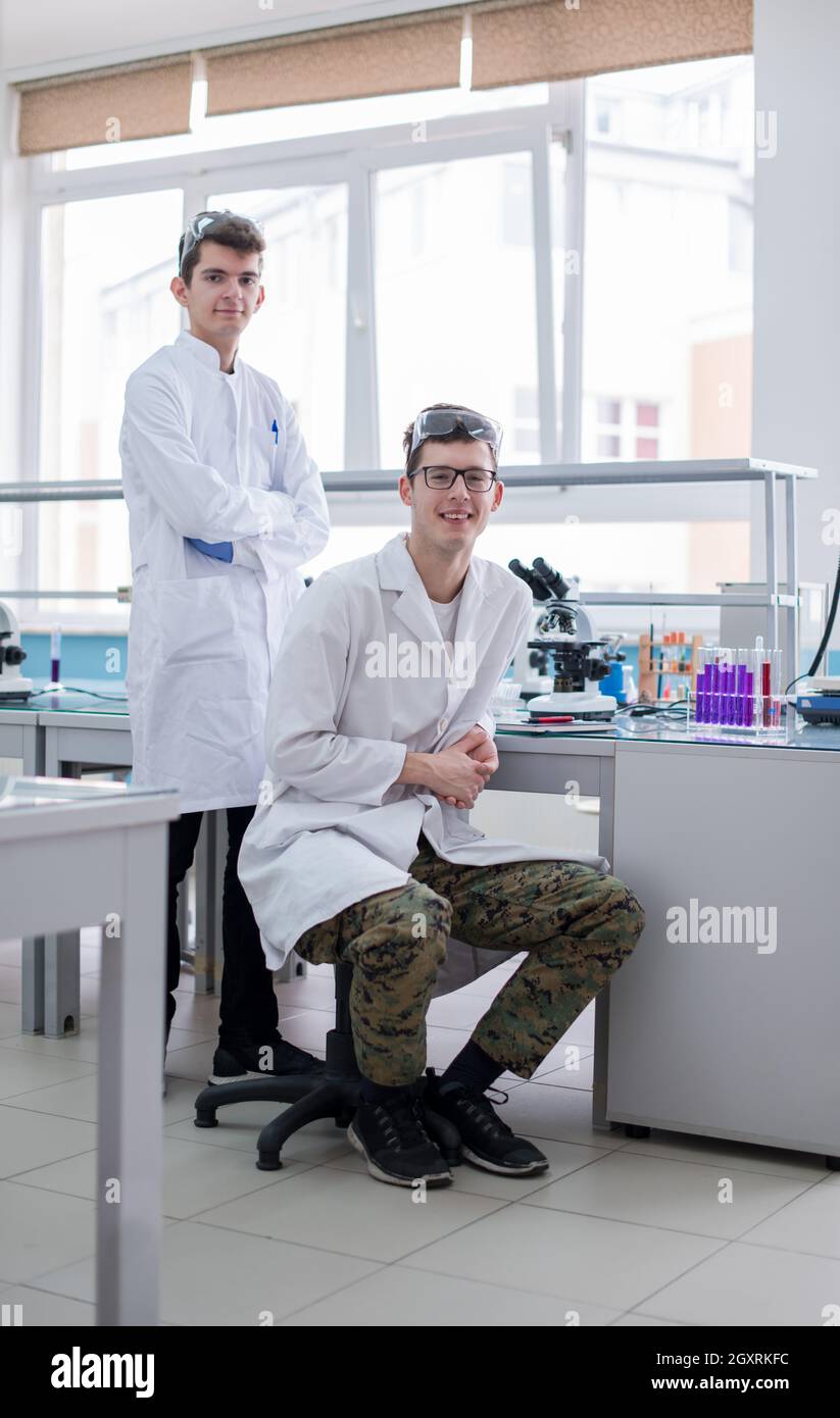 Group of young medical students doing research together in chemistry ...