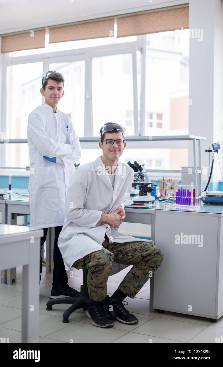Group of young medical students doing research together in chemistry ...